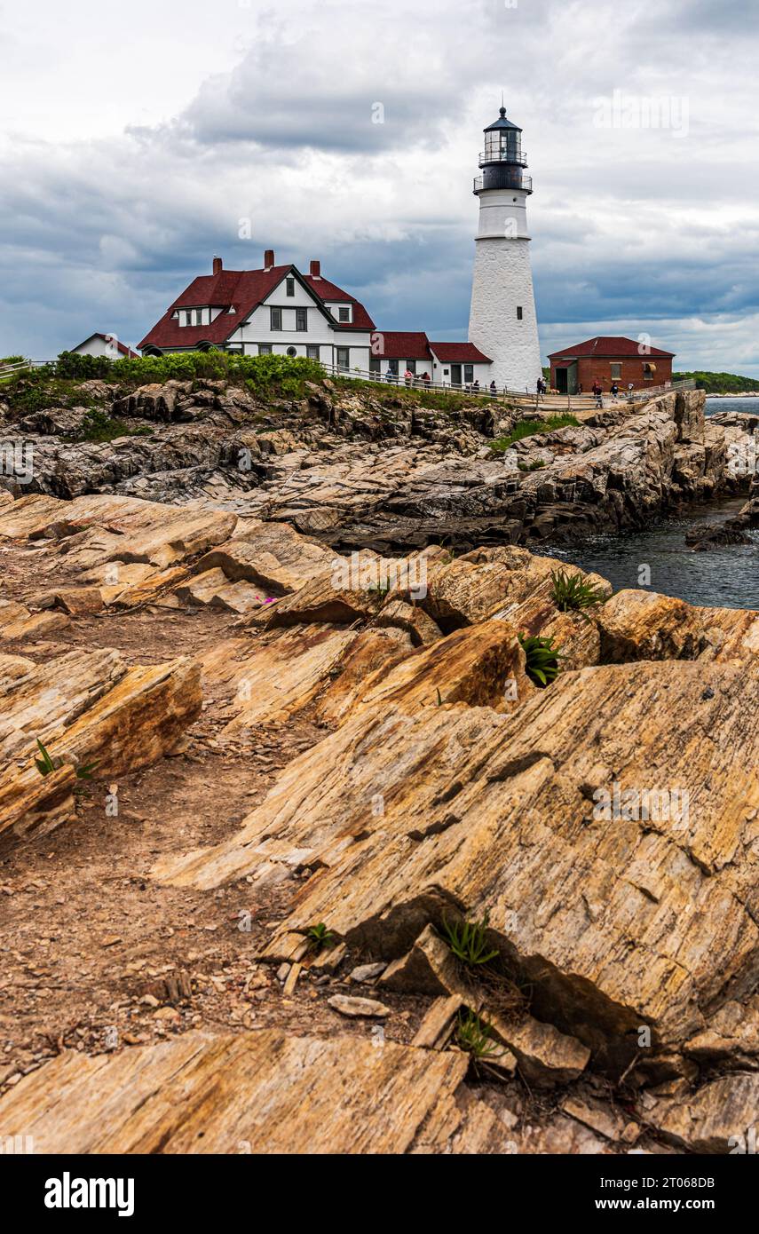 The Portland Head Lighthouse located on the rocky New England shore of ...