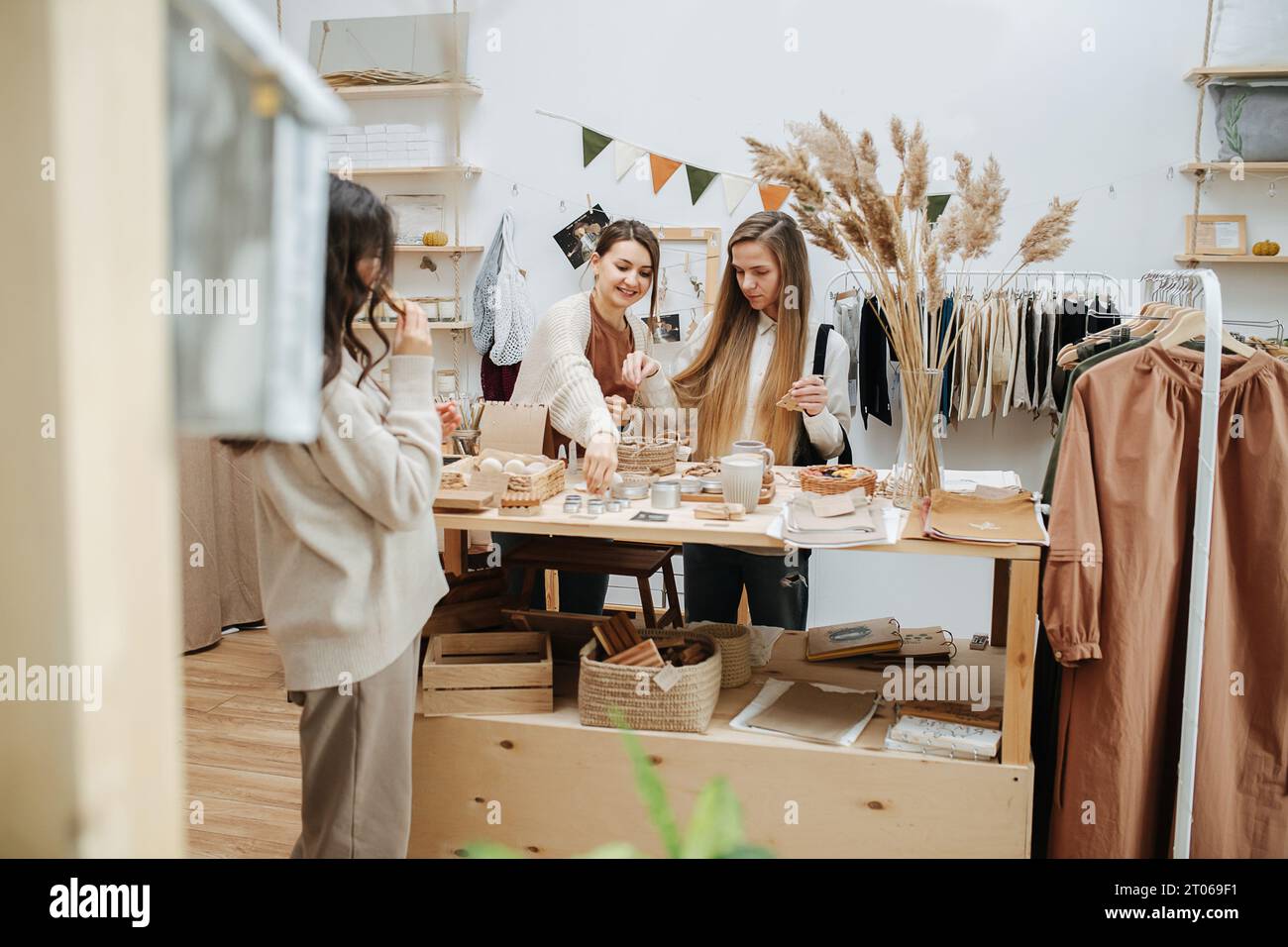 Scene in an eco store where girls make their selection of handmade ...