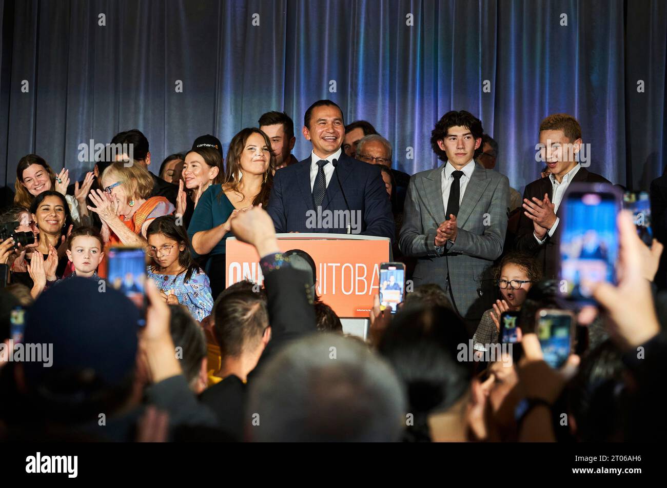 Manitoba NDP leader Wab Kinew delivers his victory speech surrounded by ...