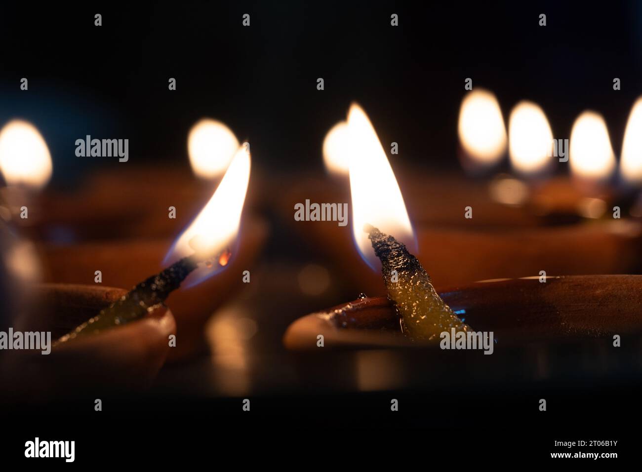 macro shot showing the burning cotton wick of diya lamp traditionally ...