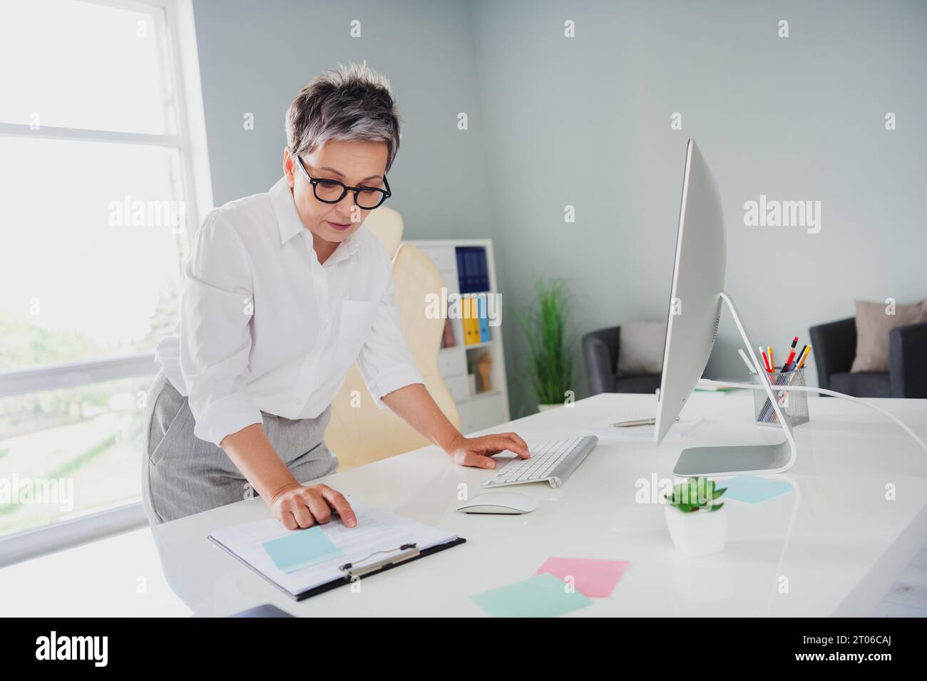 Photo of confident busy lady assistant wear white shirt reading ...