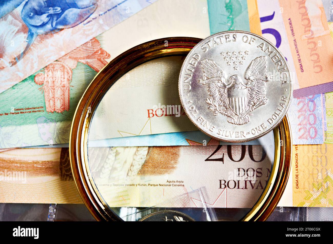 American silver dollar coins and venezuelan bolivars banknotes ...
