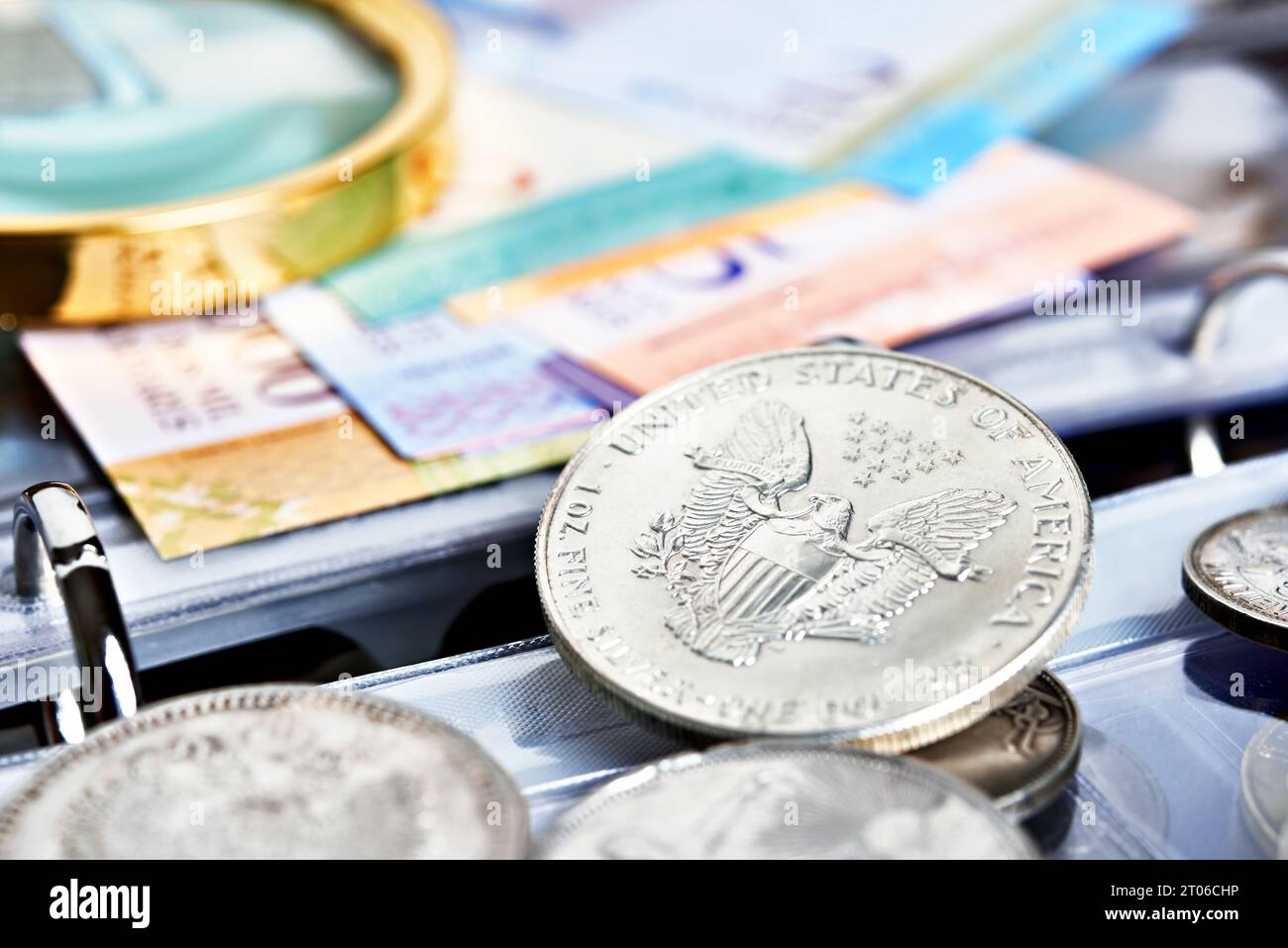 American silver dollar coins and venezuelan bolivars banknotes ...