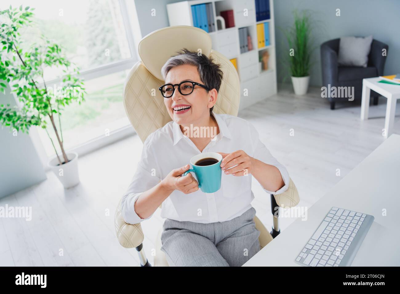 Photo of programmer mature aged woman hold best coffee cappuccino in city good morning look ...