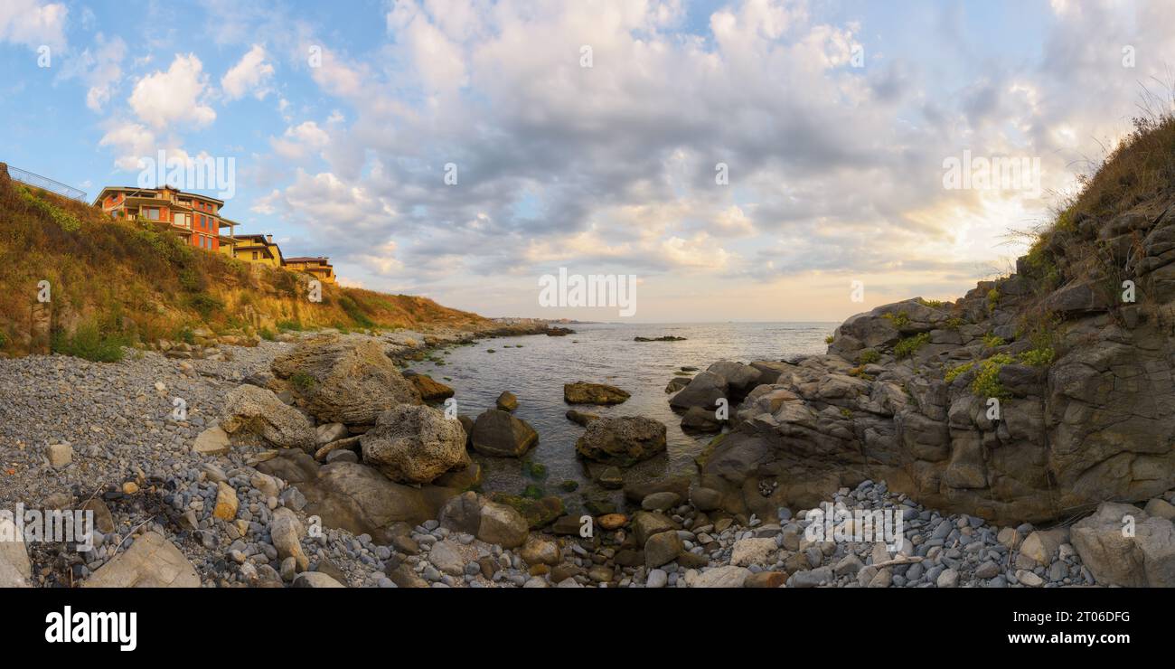 pebble coast at sunrise. gorgeous view of seascape on a cloudy morning ...