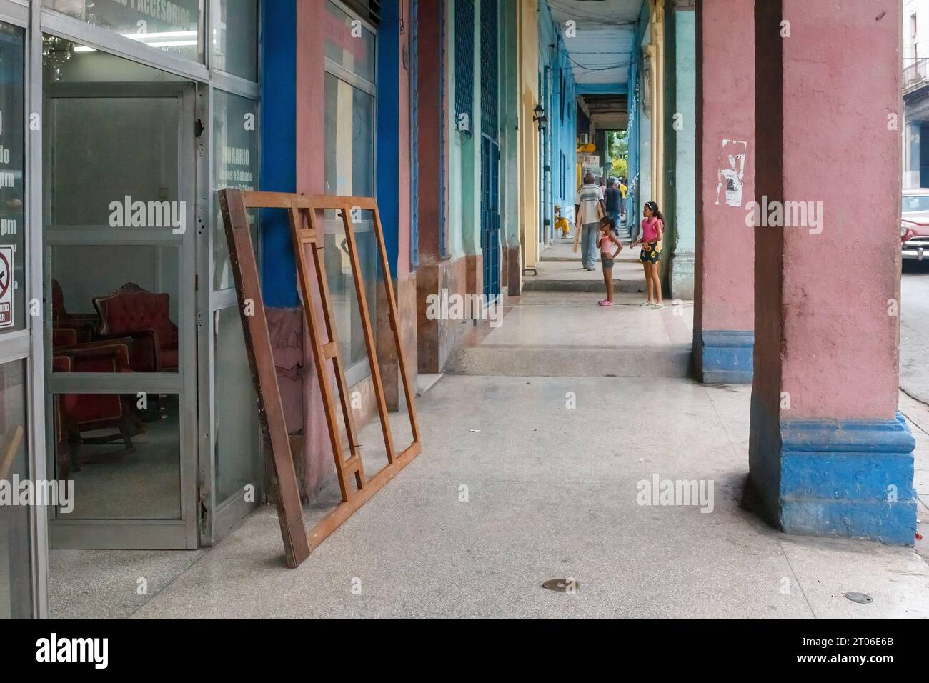 A wood frame of a window is leaning against the aluminum and glass ...