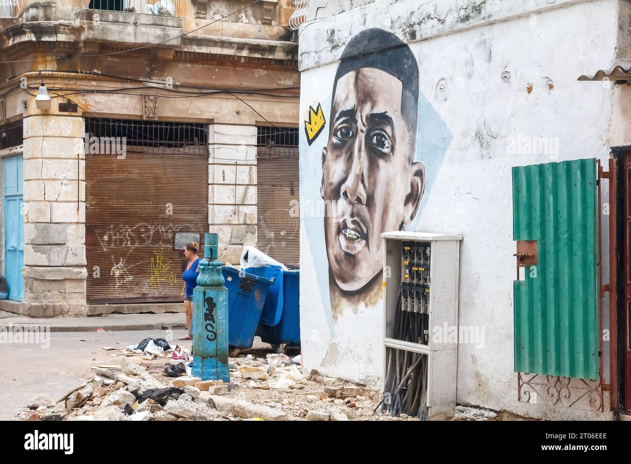 An urban painting with a male likeness is in the wall of a building ...