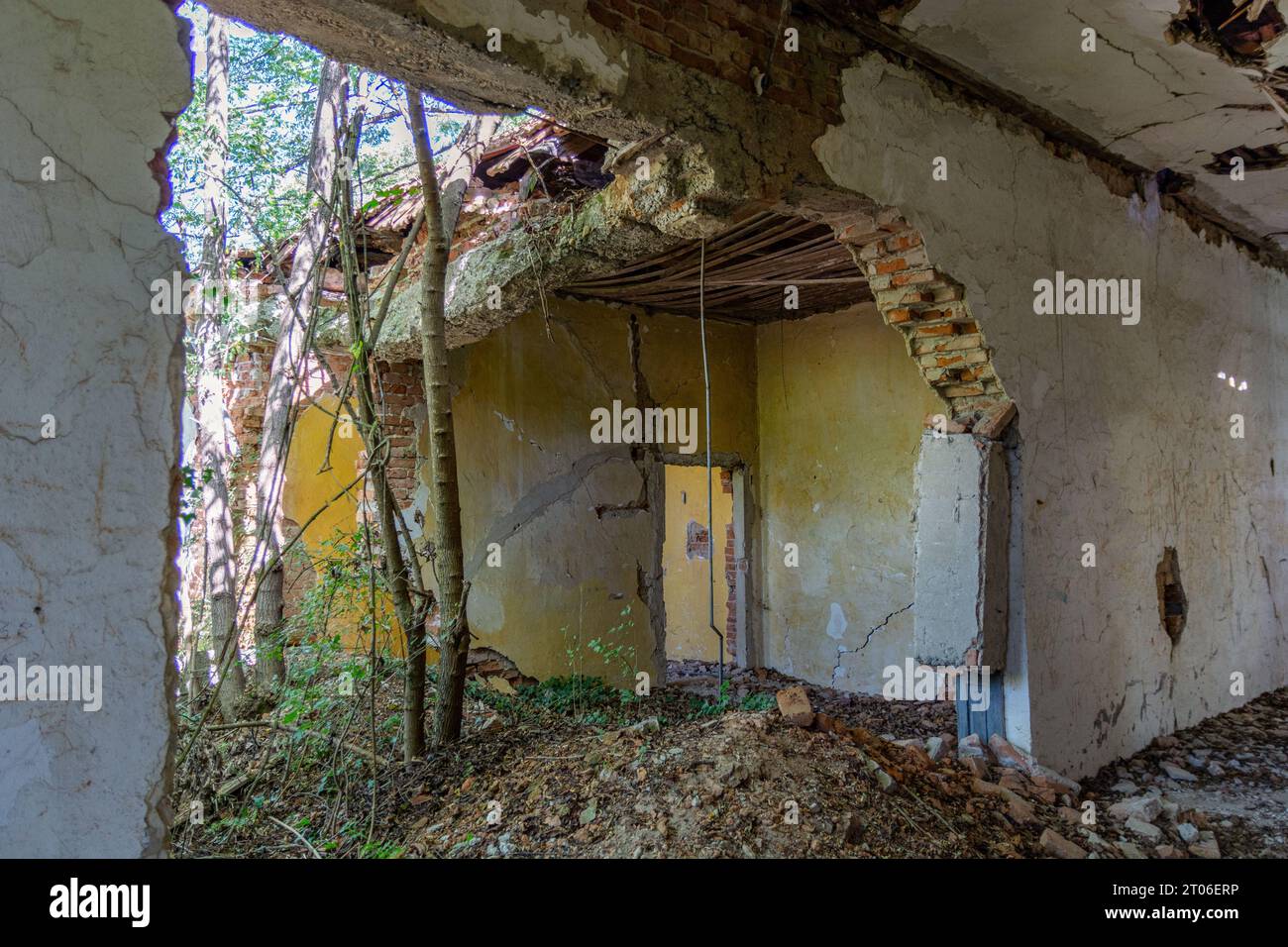 The ruins within an old and decrepit building, with a collapsed wall ...