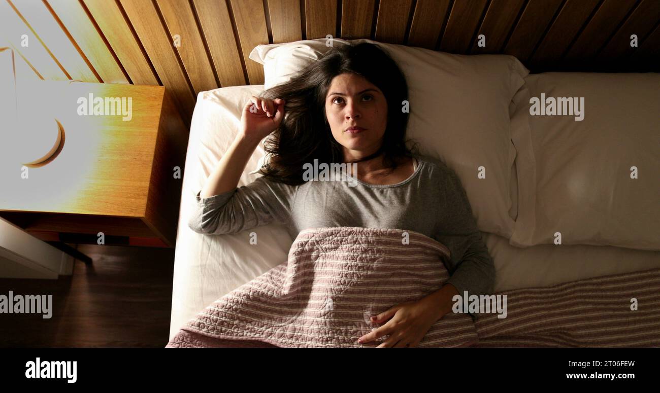 Worried woman unable to sleep suffering from insomnia. Person tossing ...