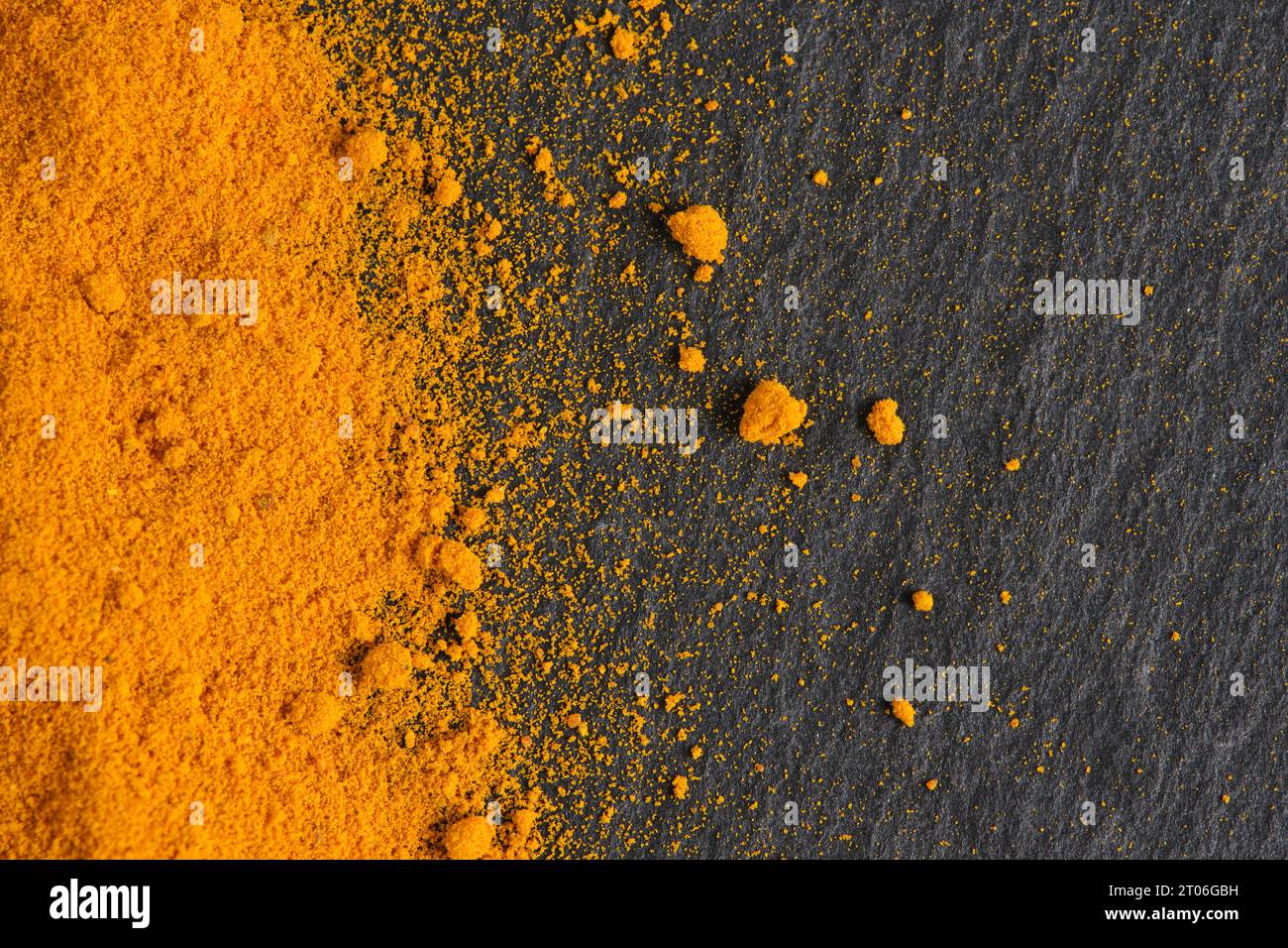 Turmeric spices slate stone background Stock Photo - Alamy