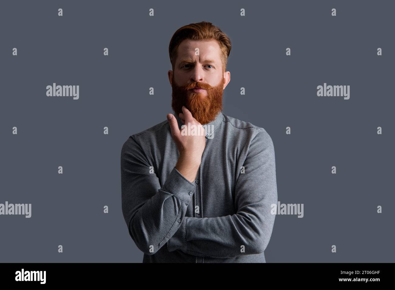 handsome unshaven man touching his beard and moustache. unshaven man ...