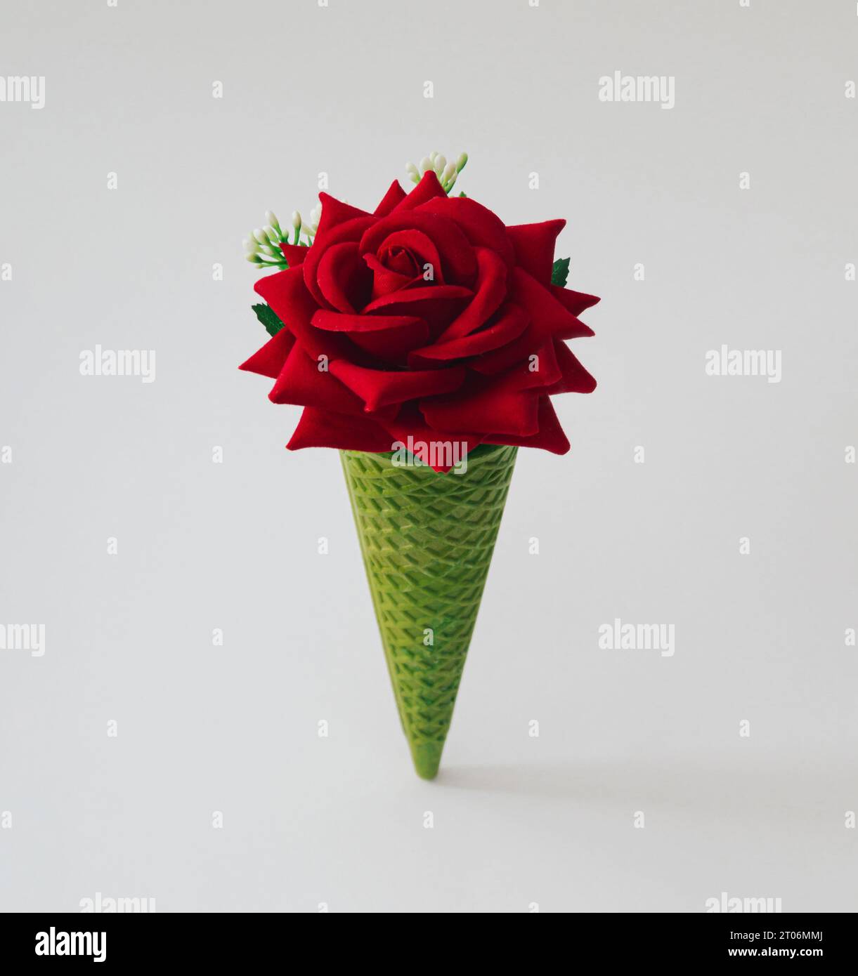 Summer layout made of red rose in green waffle ice cream cone on white ...