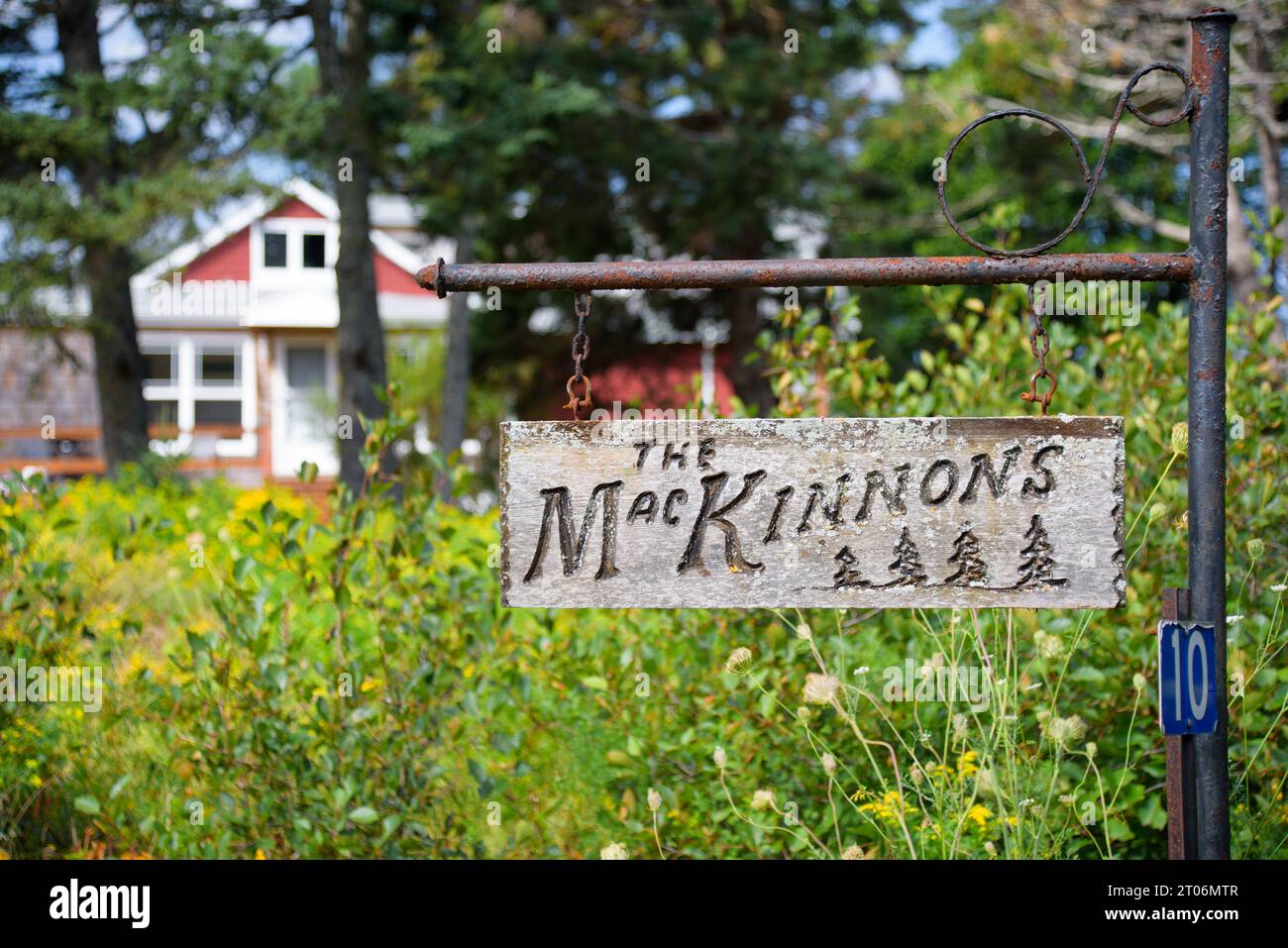Weathered wooden family name sign in front of a home in Stanhope ...