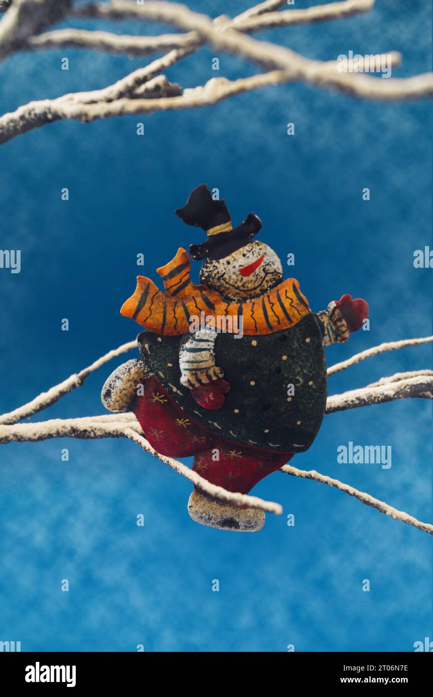 Snowman flying in the air between Christmas trees. Creative winter ...