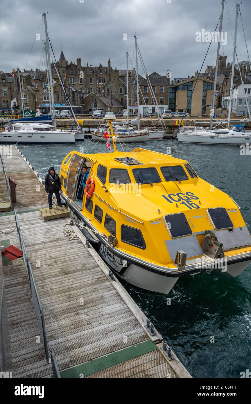 Yellow AIDA Bella lifeboat at the port of Shetland Island waiting for ...