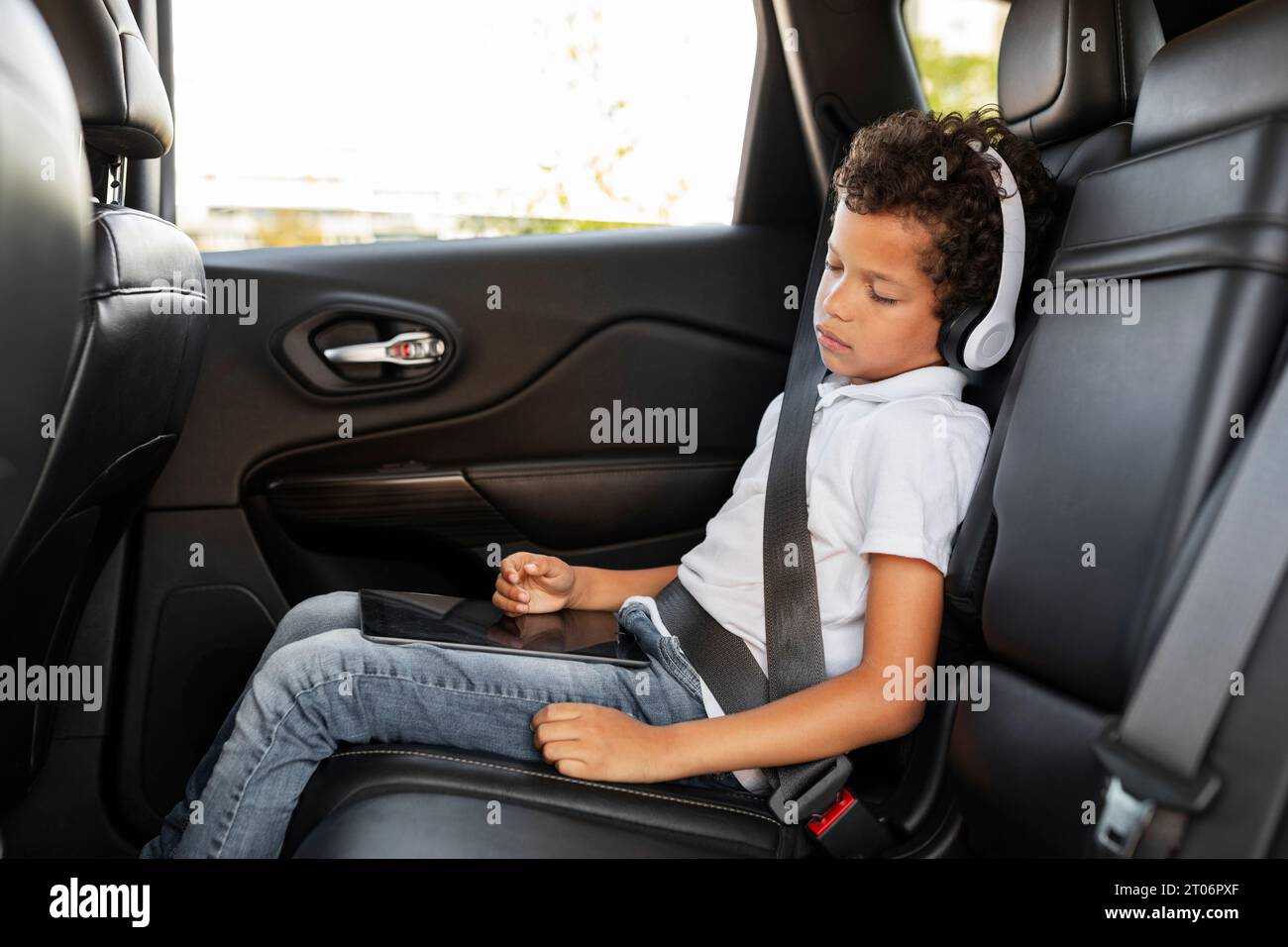 Tired black guy child sitting at car back seat, sleeping Stock Photo ...