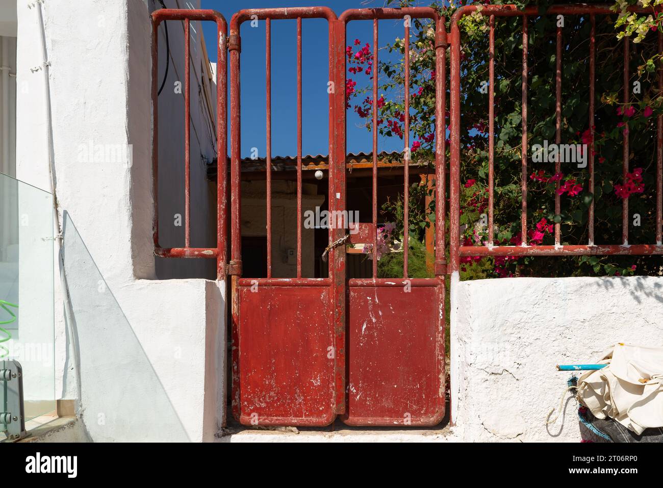 Red metal gate along the beach. Agia Pelagia, Crete, Greece Stock Photo ...