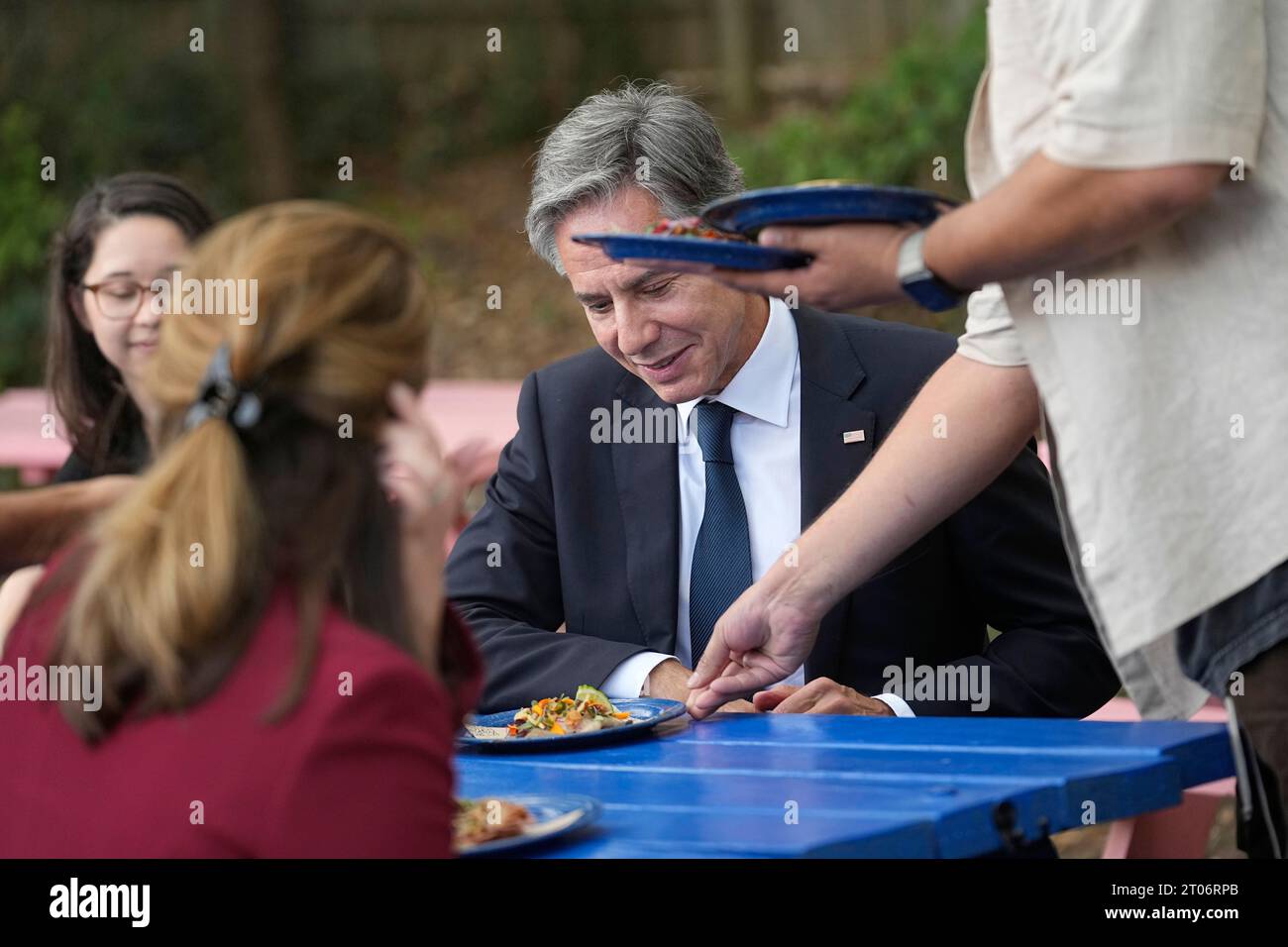 Secretary of State Antony Blinken, center, is served lunch by Nixta ...
