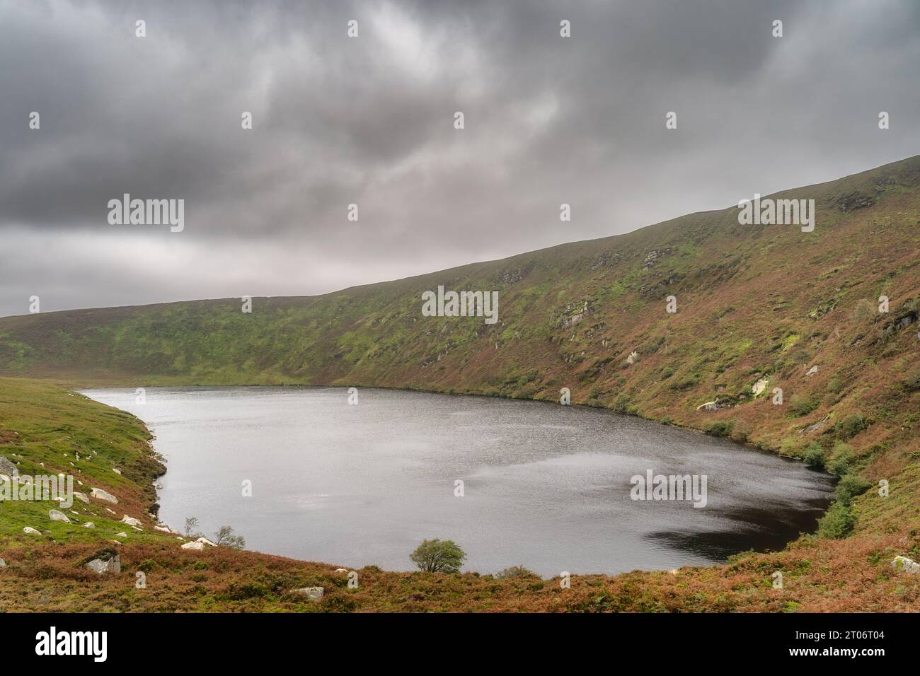 Lake, Lough Bray surrounded by mountains and covered in moody, dramatic ...