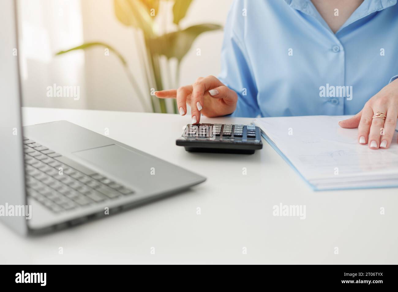 Unrecognisable businesswoman calculates on calculator expenses, fees ...