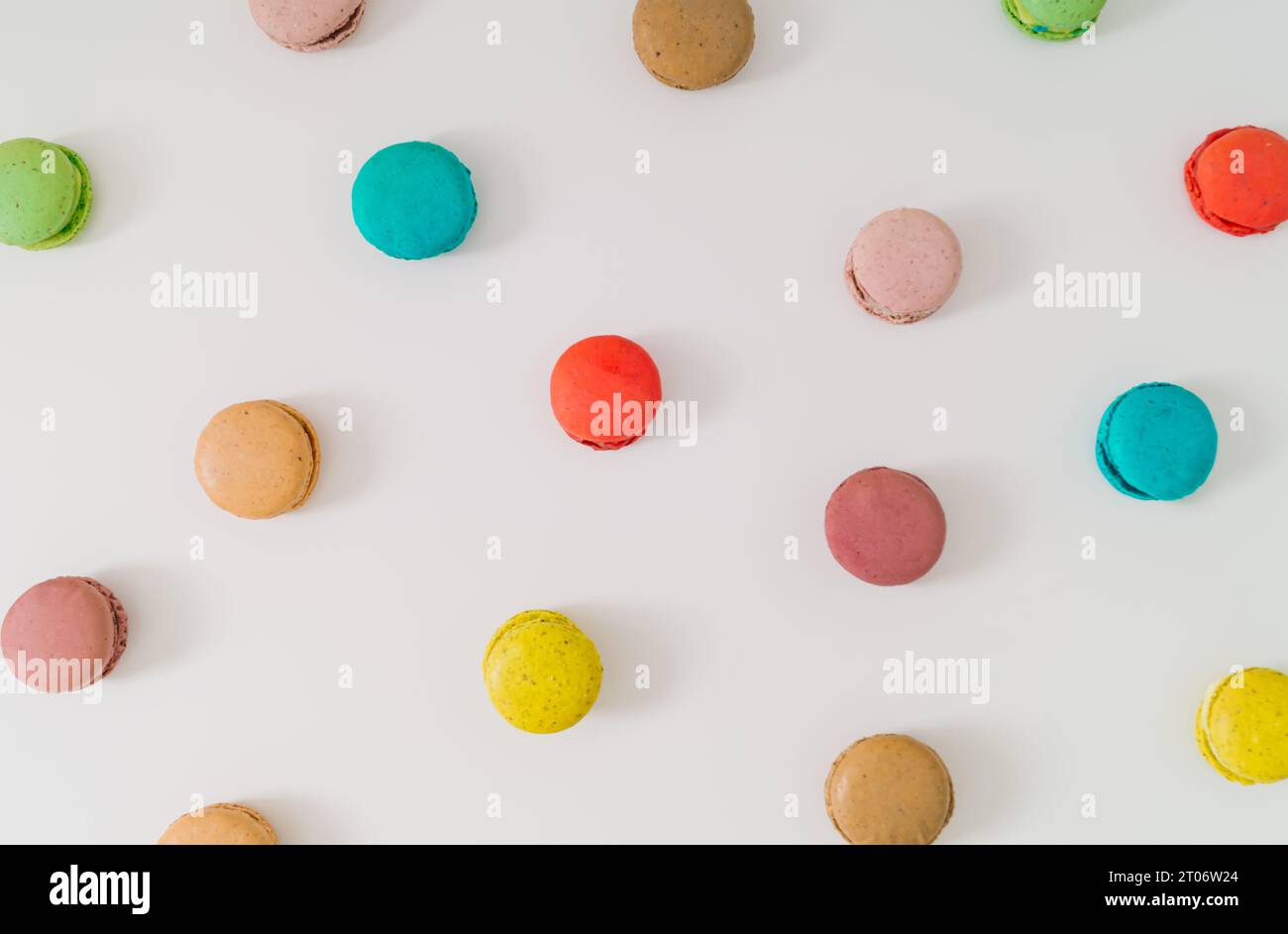 Creative colorful pattern made of various macarons on white background ...