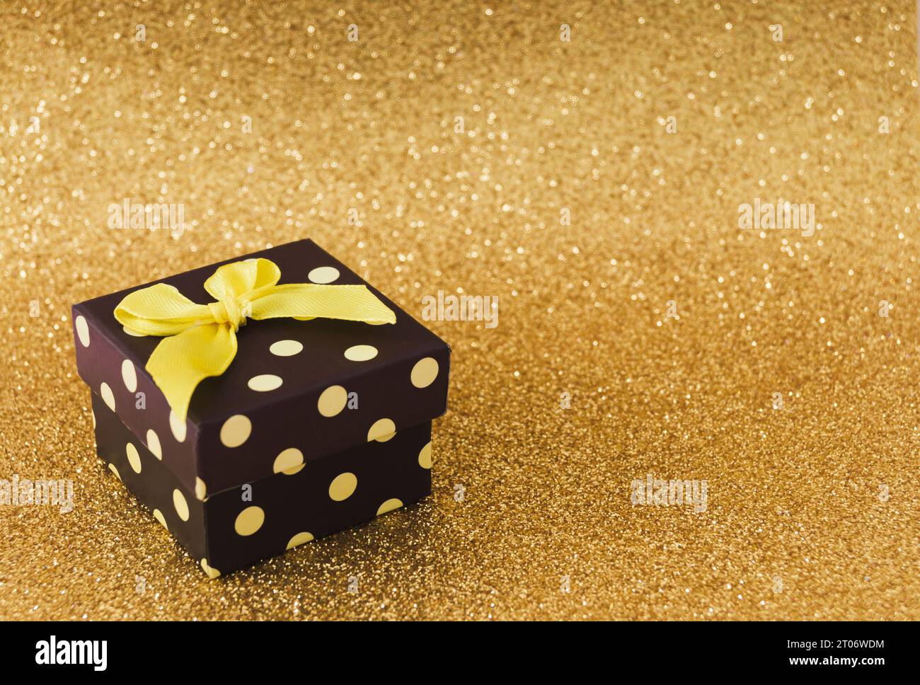 Closeup view minimal composition of Christmas gift box on golden ...