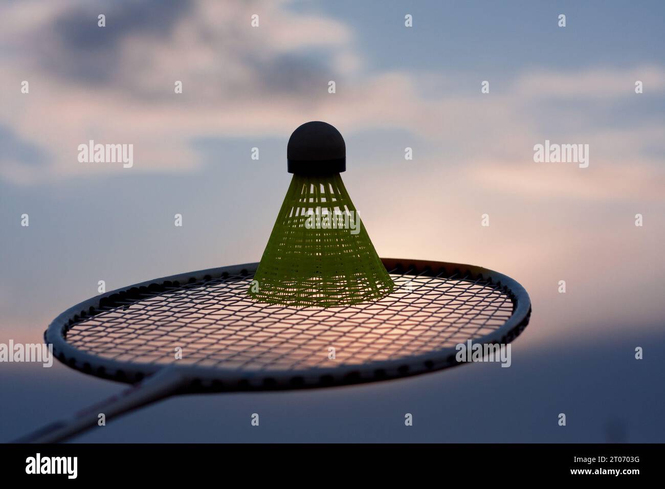 Yellow shuttlecock and badminton racket background sunset sky. Sports ...