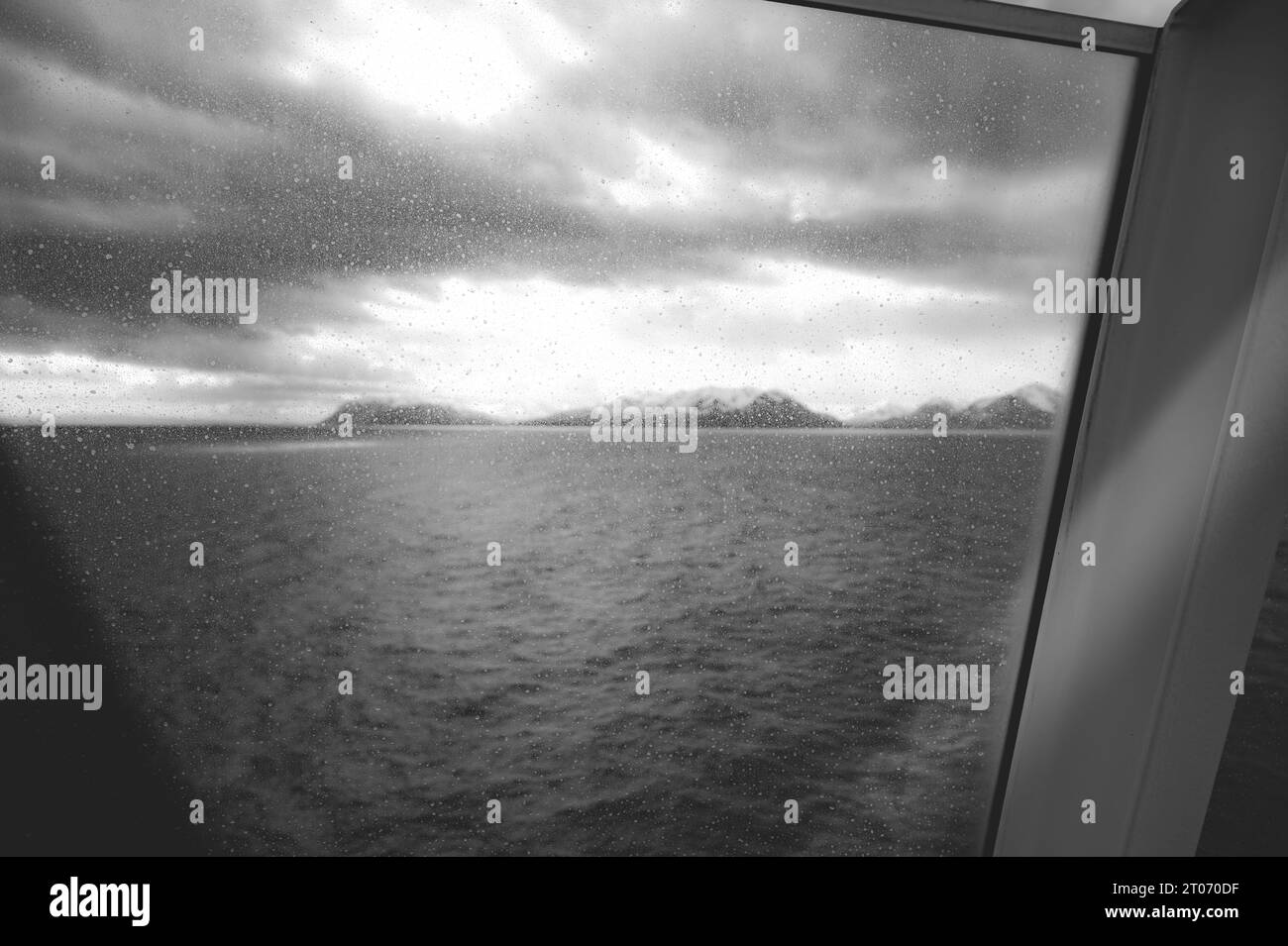 Iceland snow mountains with sea, window with rain in front background ...