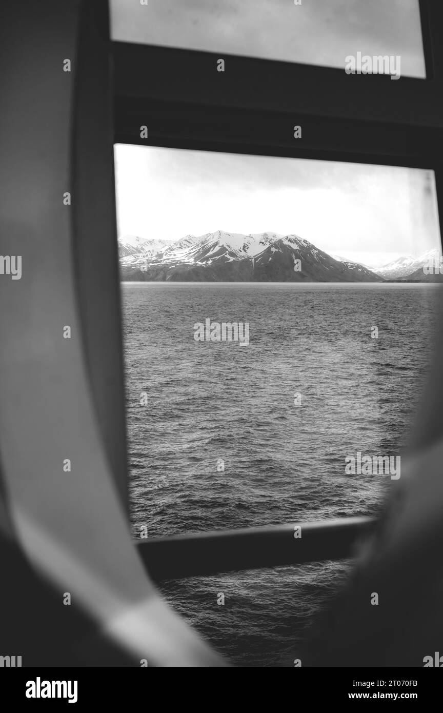 Iceland snow mountains with sea, window with rain in front background ...