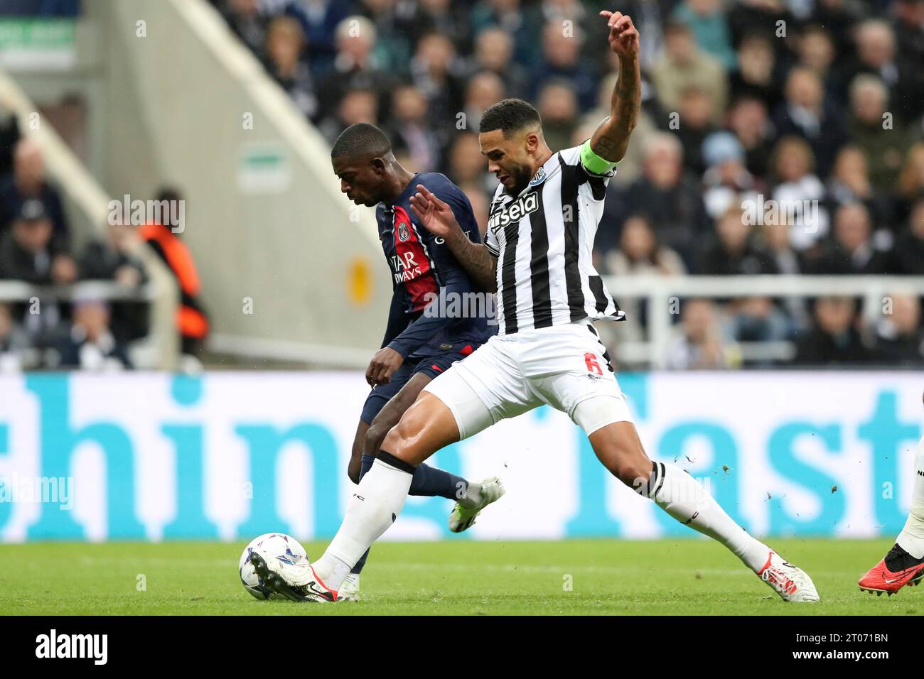 Newcastle's Jamaal Lascelles, right, and PSG's Ousmane Dembele vie for ...