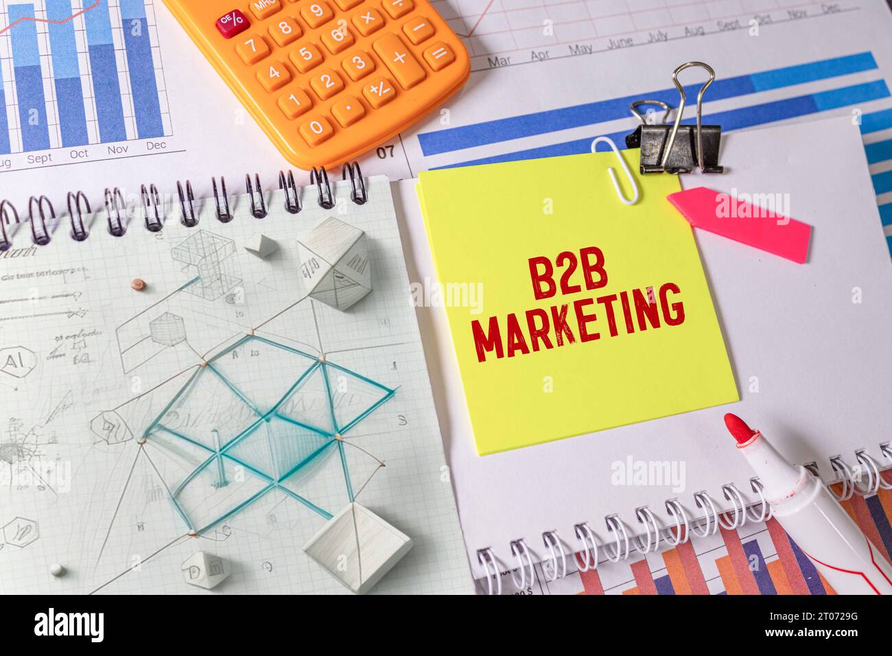 B2B Marketing text on a notebook with clipboard and calculator on white ...