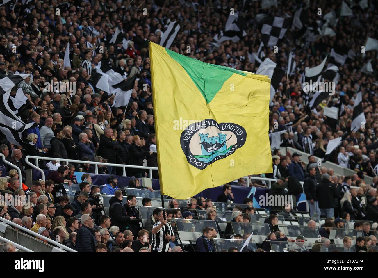 Newcastle United fans wave flags during the UEFA Champions League match ...