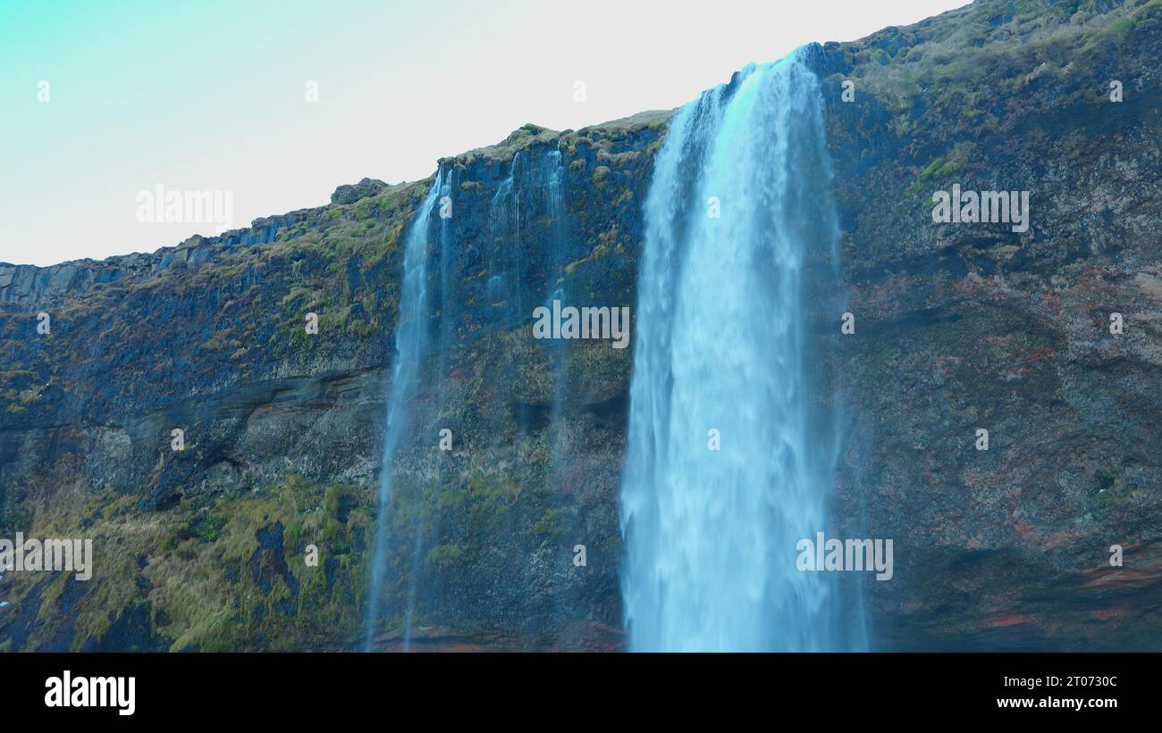 Beautiful waterfall in reykjavik iceland with water flowing off cliffs ...