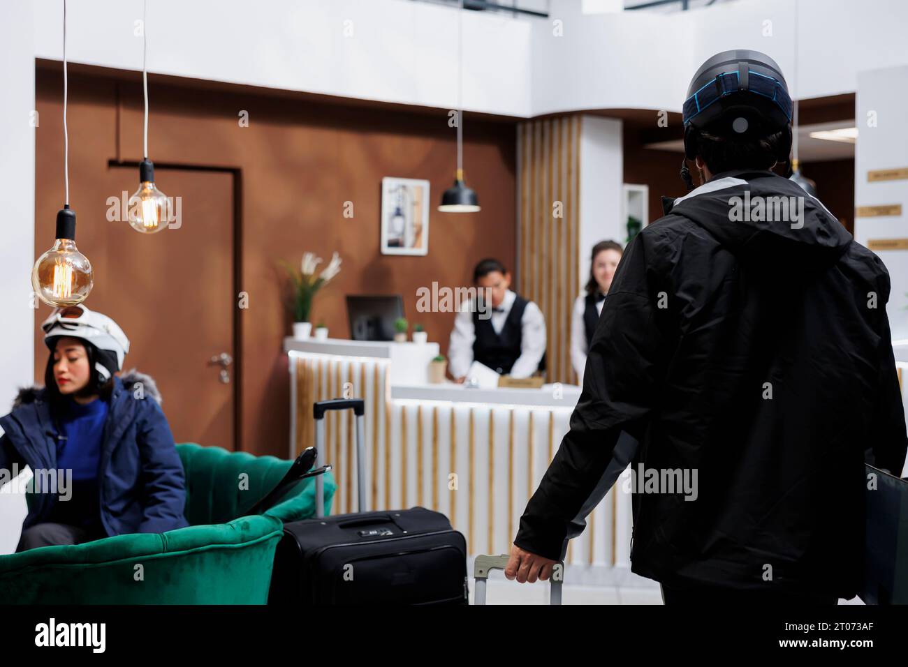 Man wearing jacket enters hotel hi-res stock photography and images - Alamy