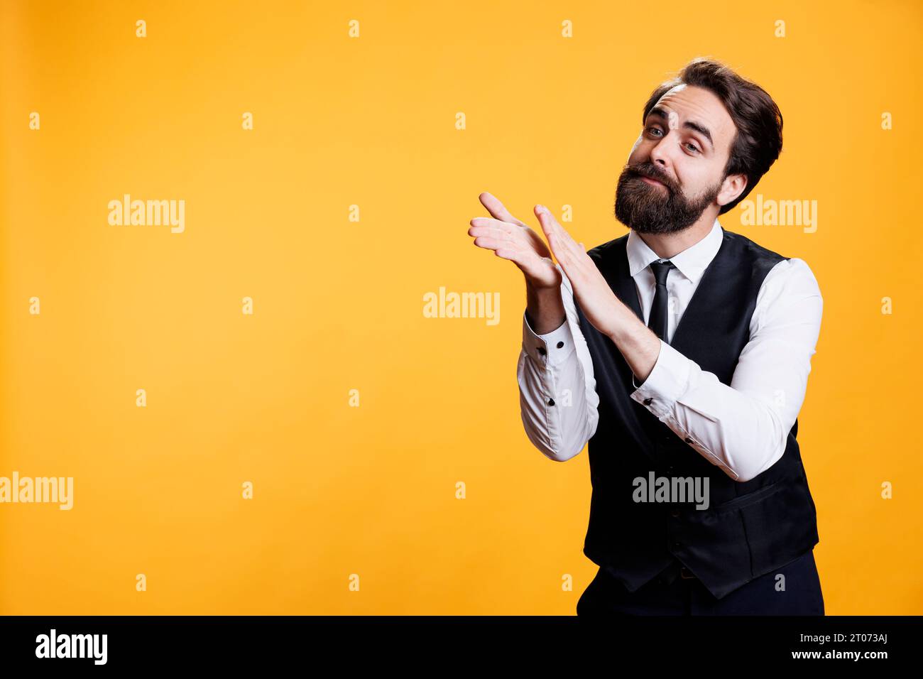 Happy waiter in suit claps hands to congratulate someone on new ...