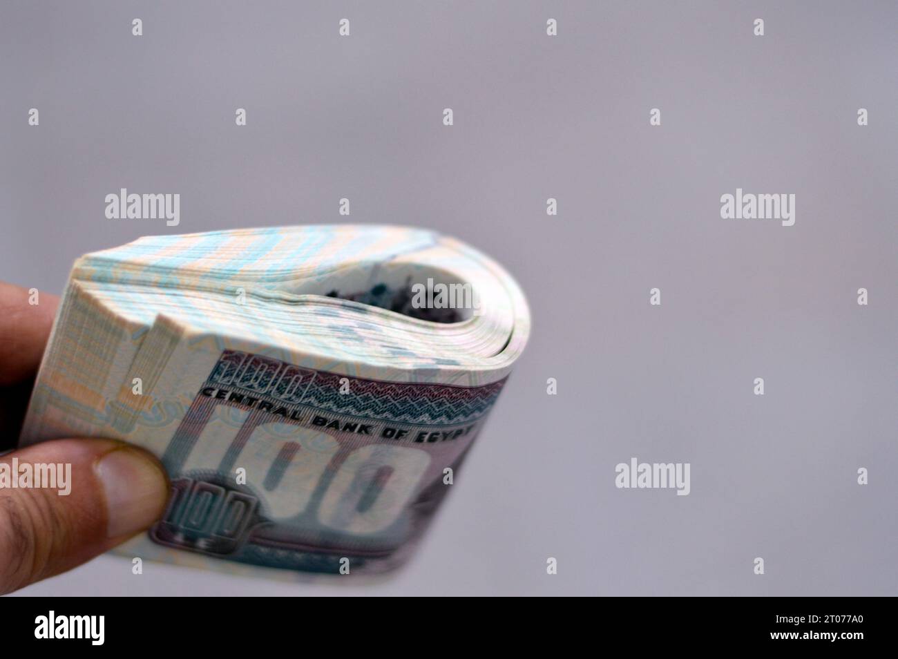 Folded 100 EGP LE one hundred Egyptian pounds cash money bills rolled ...