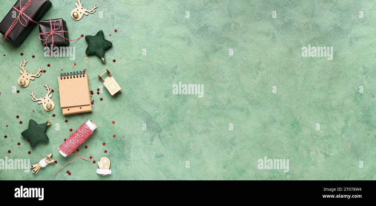 Blank paper calendar with gift boxes and Christmas decorations on green ...