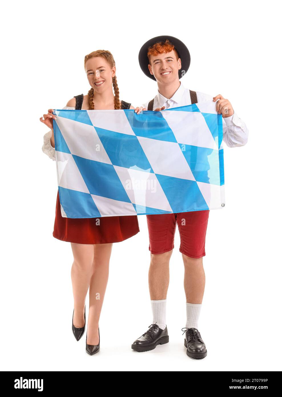 Young couple in traditional German clothes with beer and Bavarian flag ...