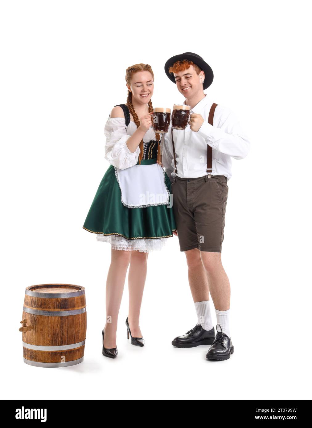 Young couple in traditional German clothes with beer on white ...
