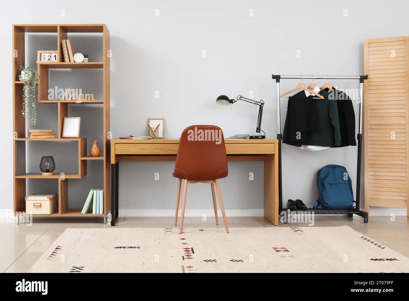 Interior of stylish room with modern workplace and school uniform on ...
