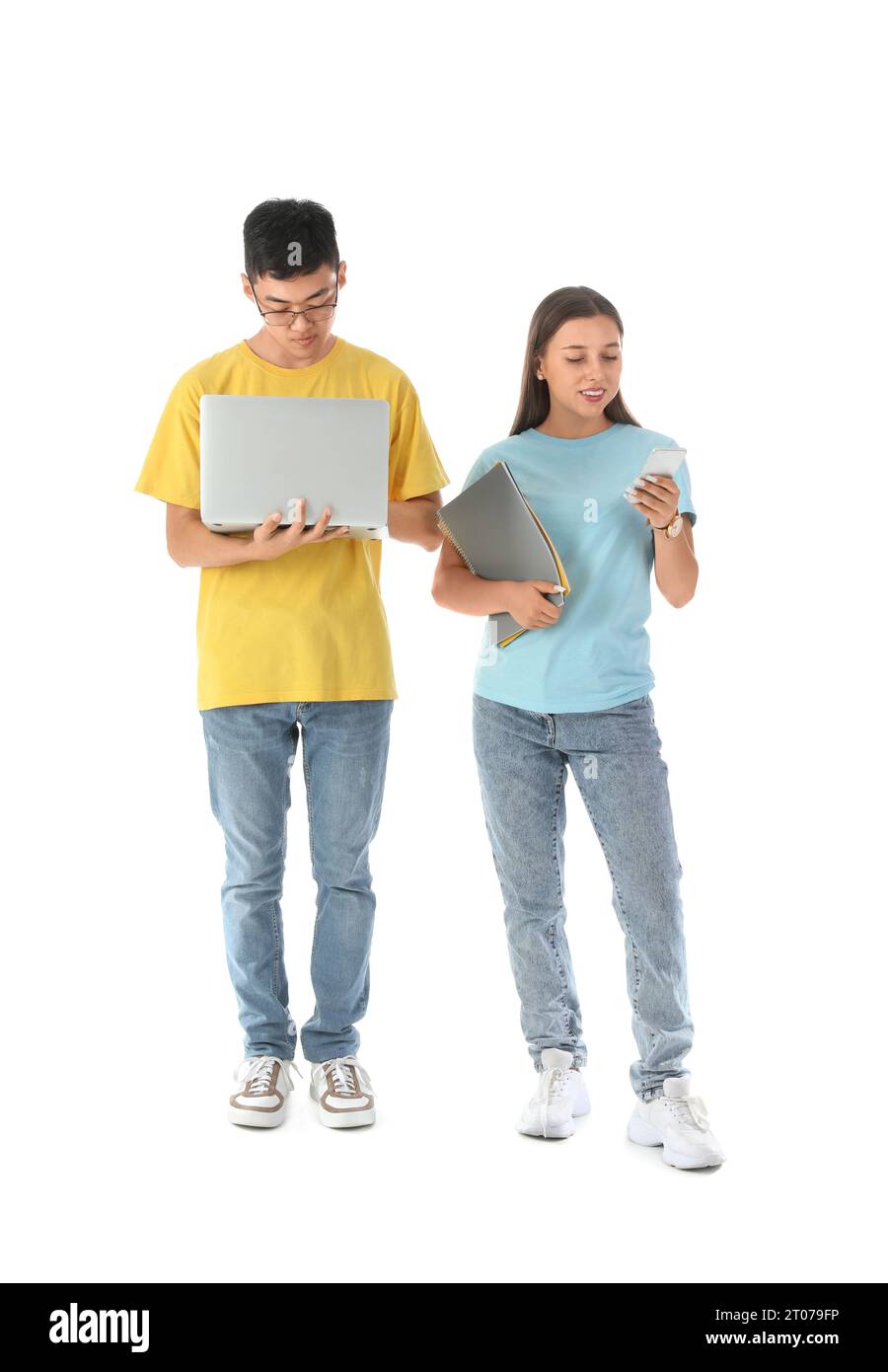 Happy students with notebooks using mobile phone and laptop on white ...