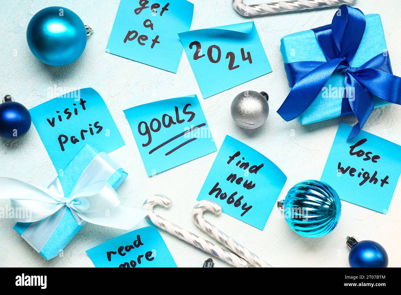 Sticky notes with different goals for 2024, Christmas balls and gift ...