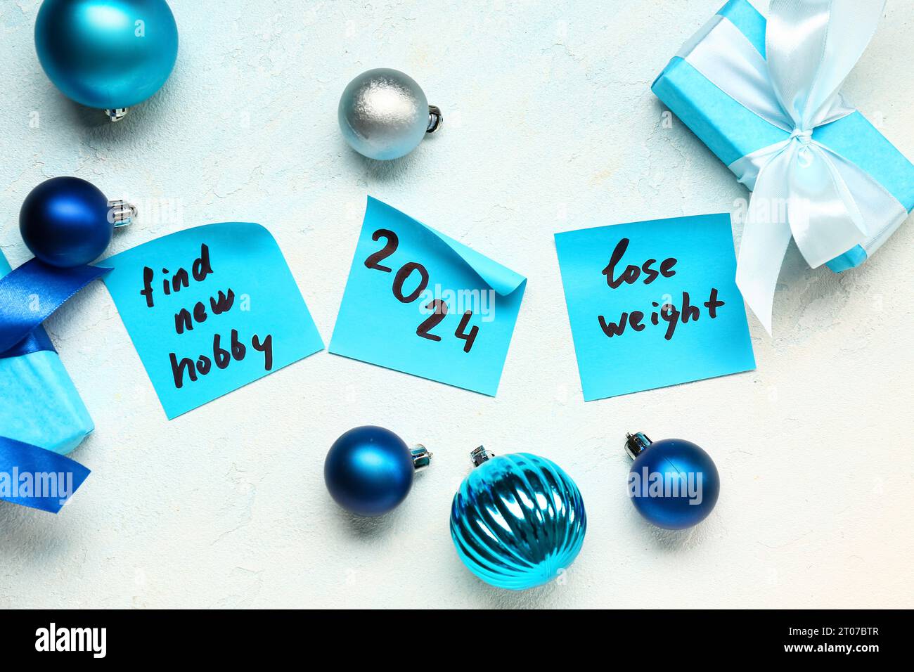 Sticky notes with different goals for 2024, Christmas balls and gift ...