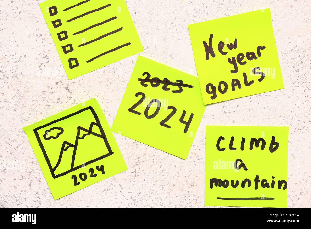 Sticky notes with different goals for 2024 on grunge white background ...
