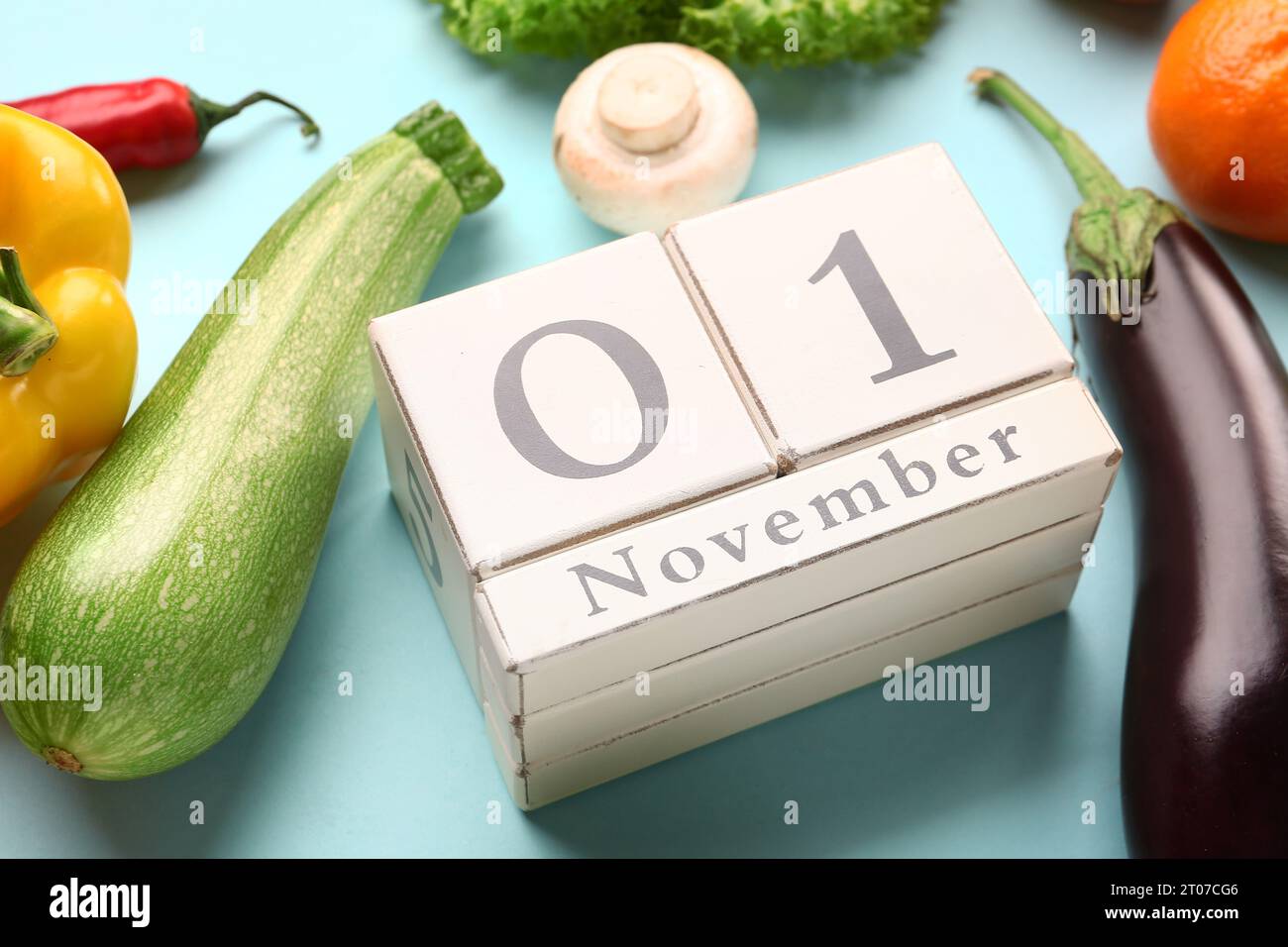 Fresh vegetables, fruits and cube calendar with date NOVEMBER 1 on blue ...