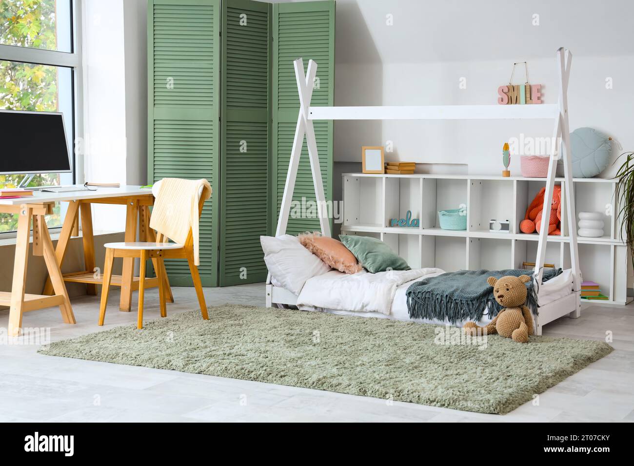 Interior of children's room with bed and study table Stock Photo - Alamy