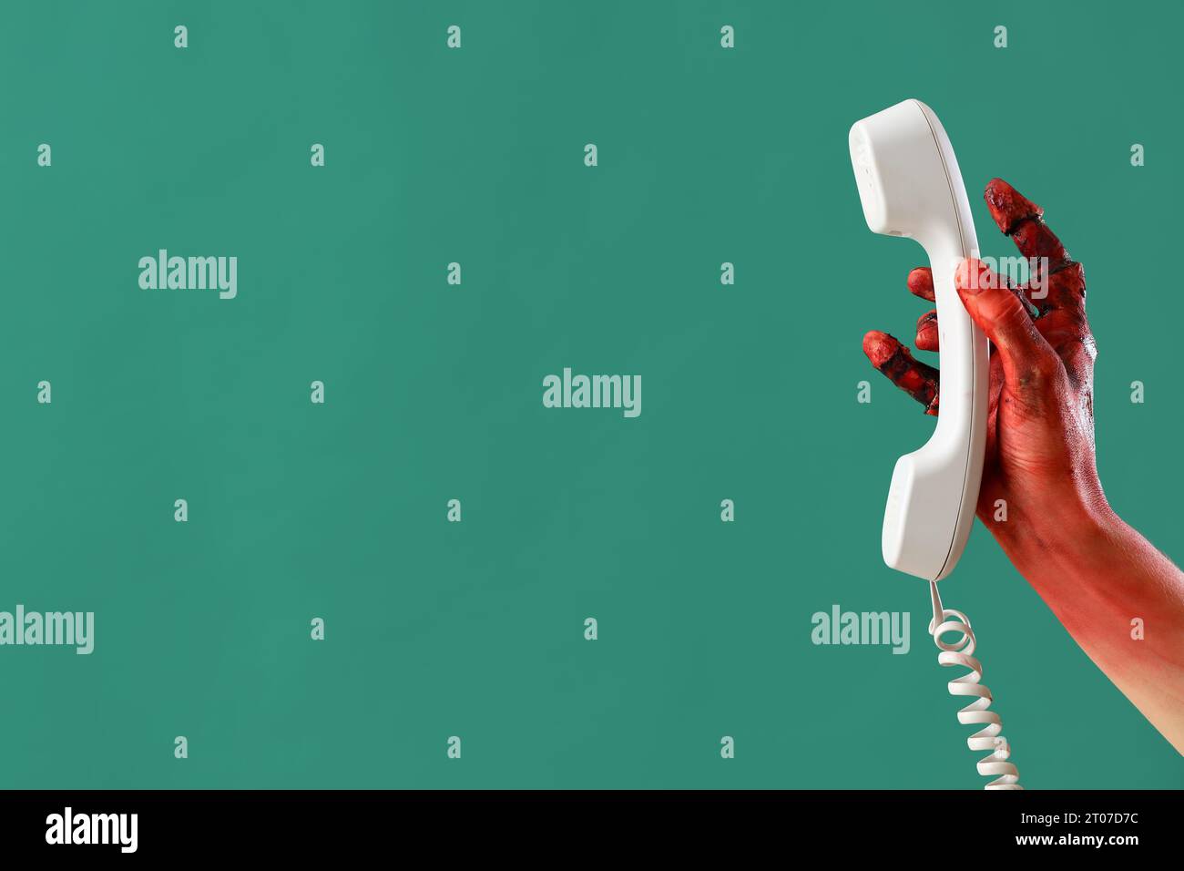 Bloodstained zombie hand with telephone on green background. Halloween ...