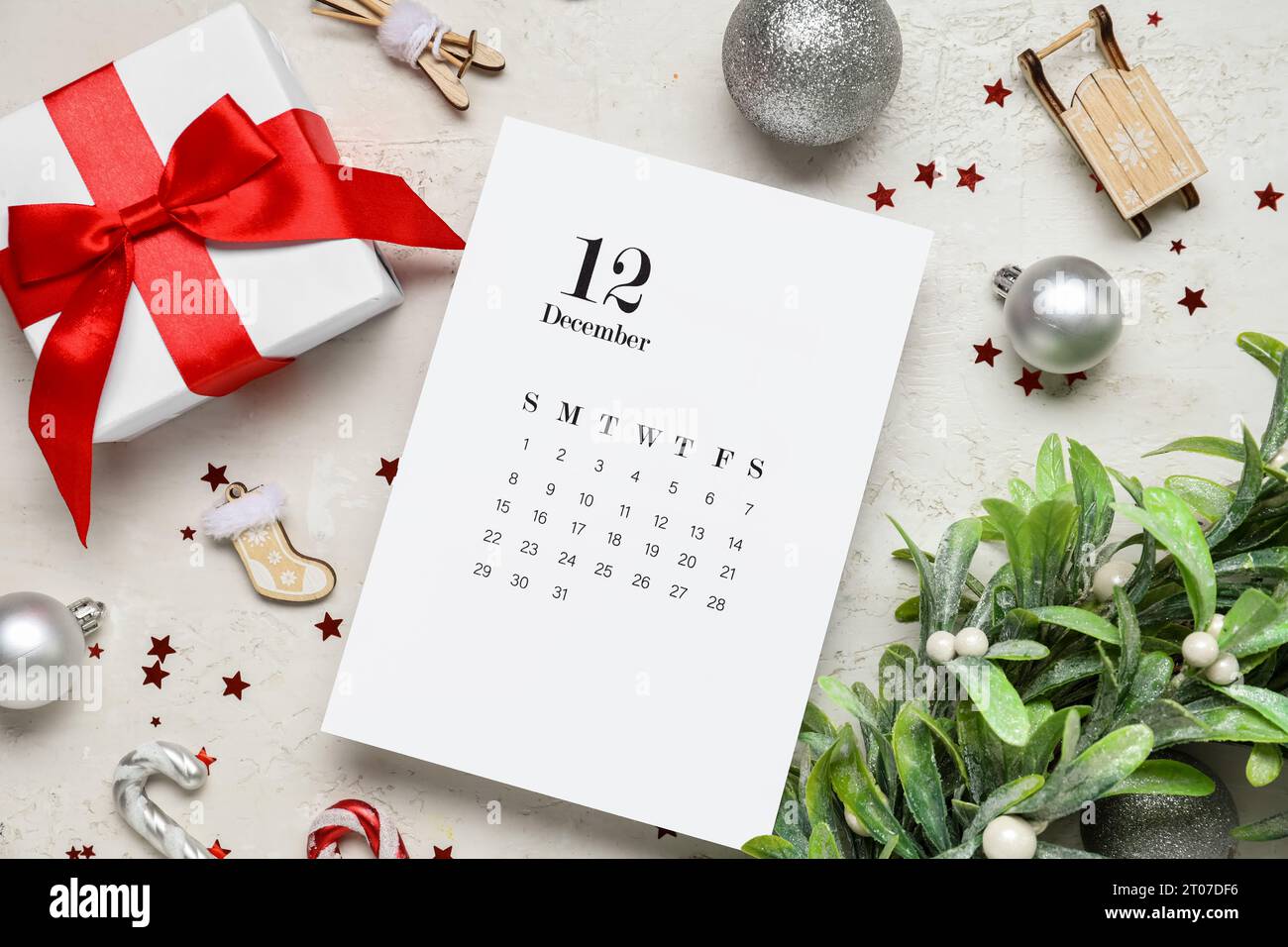 Paper calendar for December 12, gift box and Christmas decorations on ...