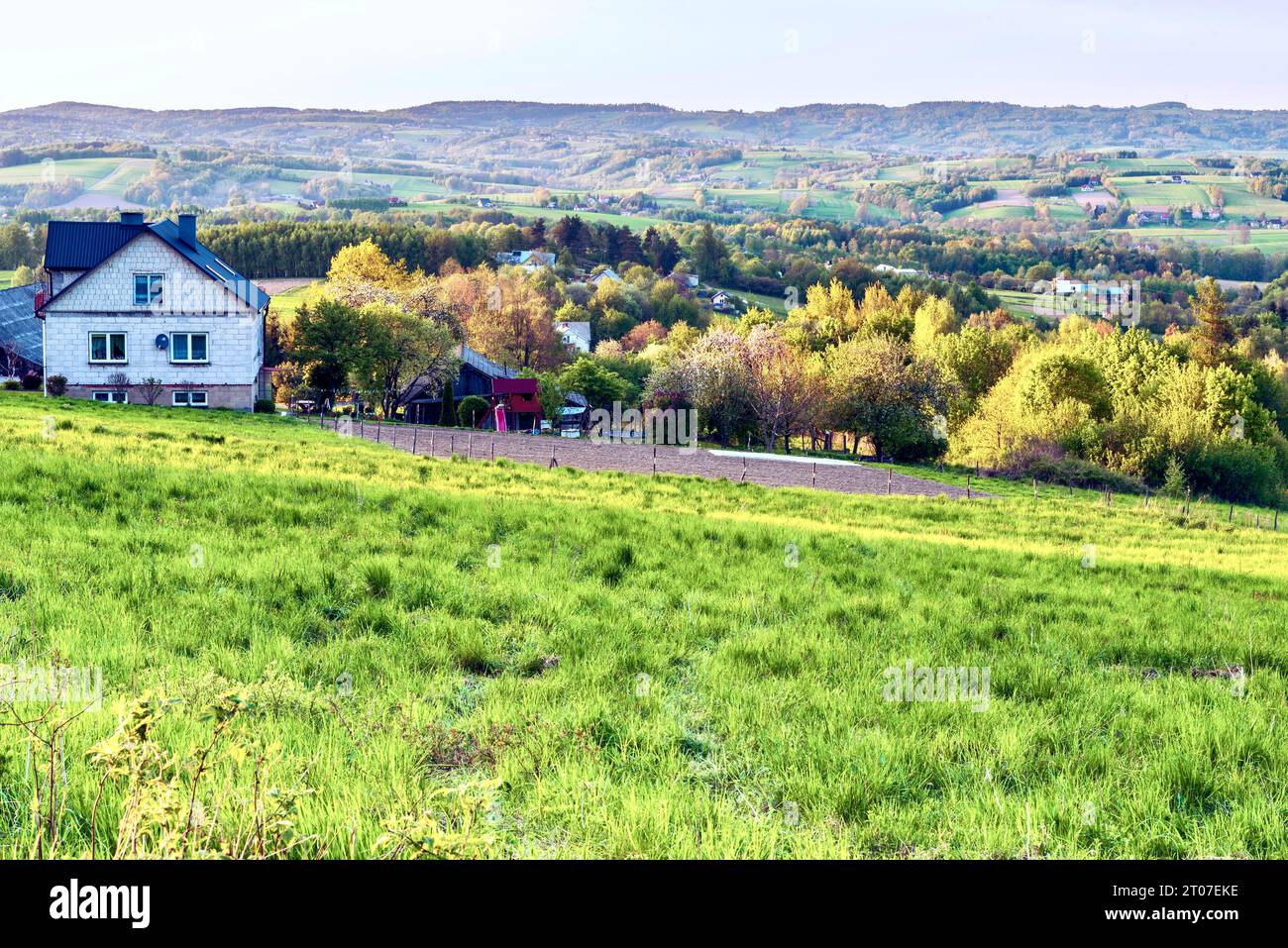 Beautiful rural landscape with village on hillside. Rural scene in ...