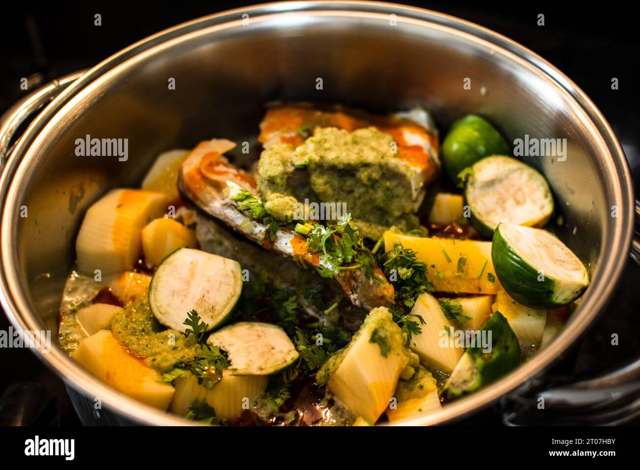 Fish being cooked with vegetables and seasonings. Healthy food. Omega 3 ...